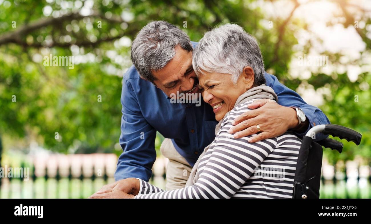 Senior couple, hug and laugh with wheelchair in park by trees for love ...