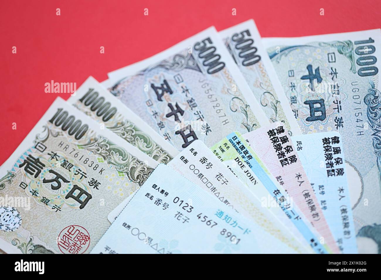 Light blue and red Japan Health Insurance cards on table with japanese ...