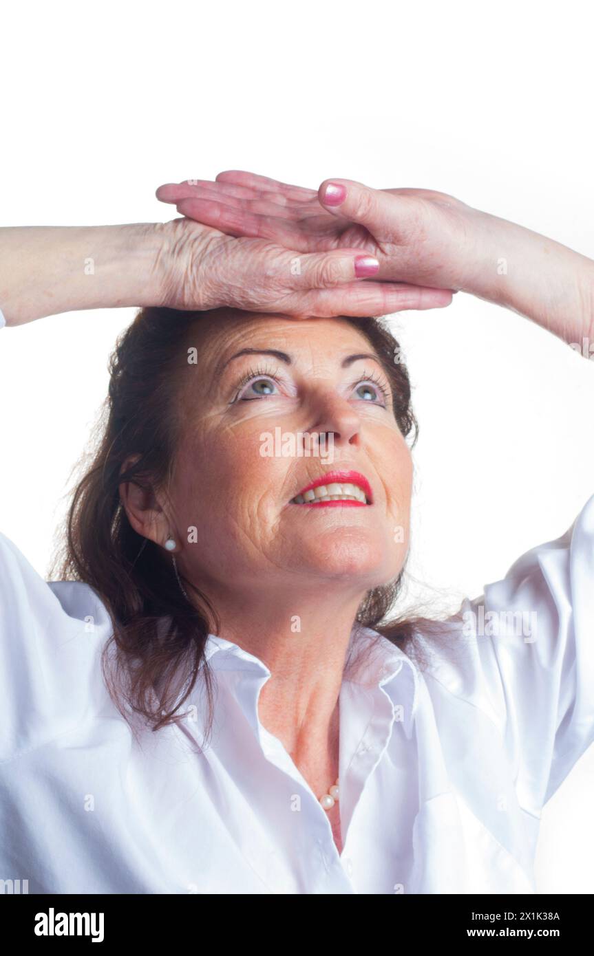 Studio shot of an expressive senior female cut out against a white ...