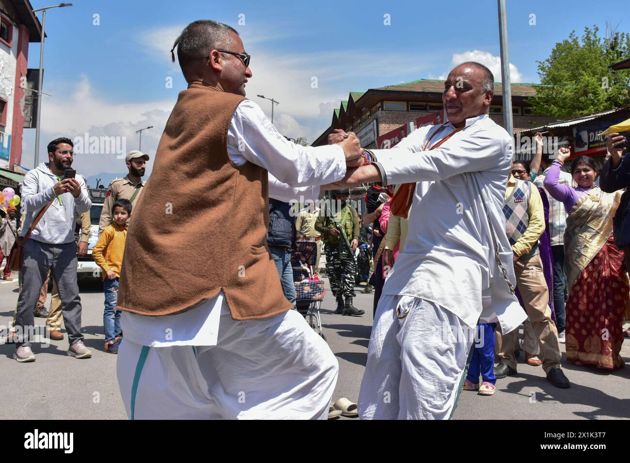 Srinagar, India. 17th Apr, 2024. Hindu devotees perform rituals during a religious procession to ...