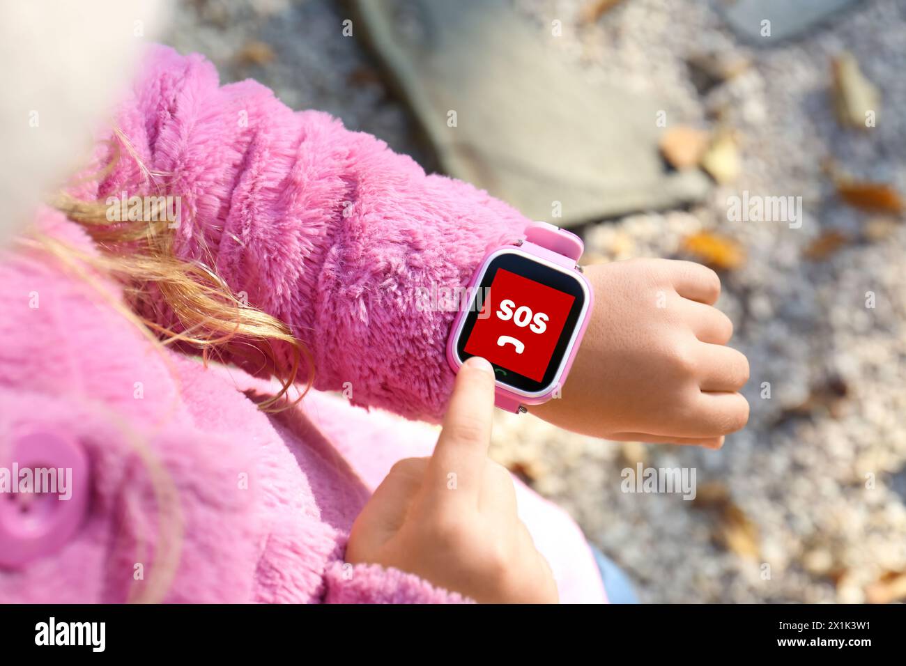 Little girl using SOS function on smartwatch outdoors, closeup Stock ...