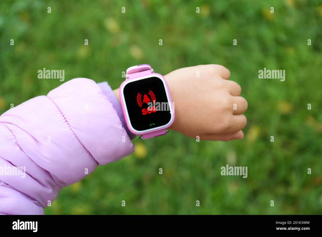 Little girl using SOS function on smartwatch outdoors, closeup Stock ...