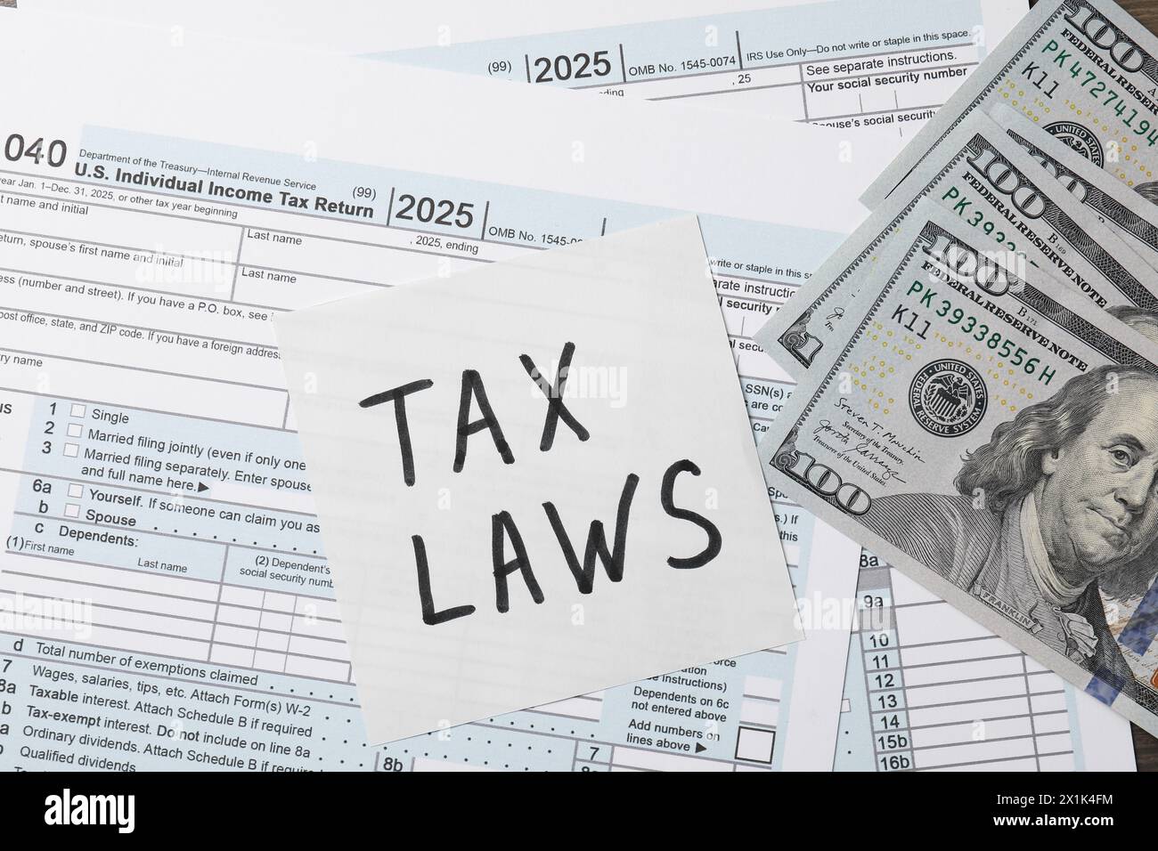 Note with words Tax Laws, forms and dollar banknotes, top view Stock ...