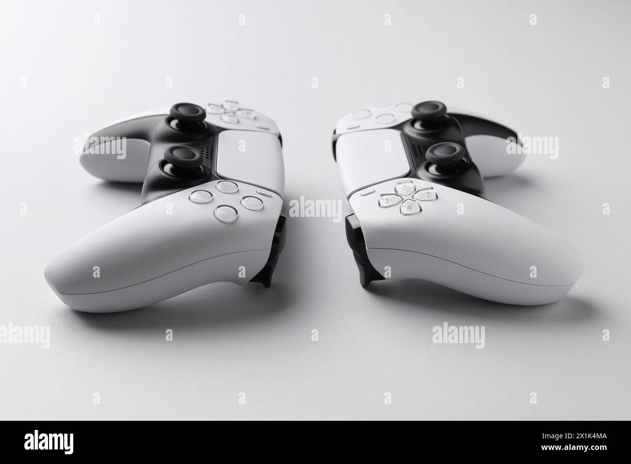 Wireless game controllers on light grey background Stock Photo - Alamy