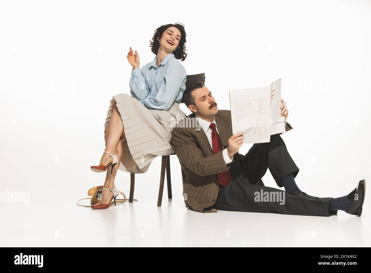 Happy smiling elegant woman sitting on chair, man in classical suit ...