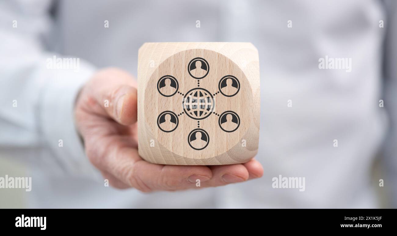 Hand holding a wooden cube with symbol of globalization concept Stock ...