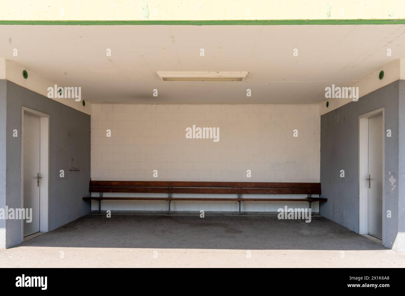 Solid bus shelter made of concrete, with a big bench at one wall Stock ...