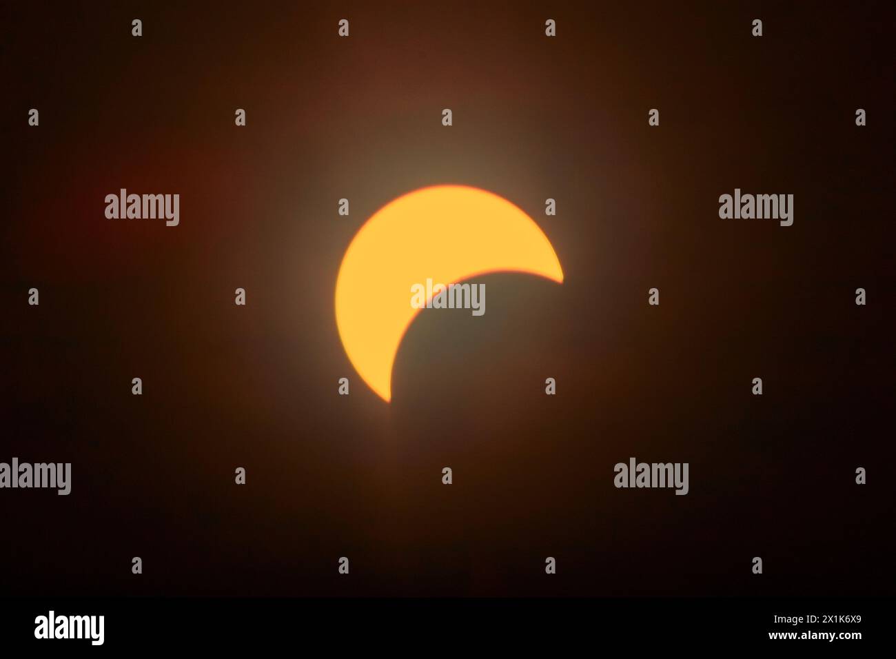 Partial Solar Eclipse with Sun's Crescent in Warm Skies Stock Photo - Alamy