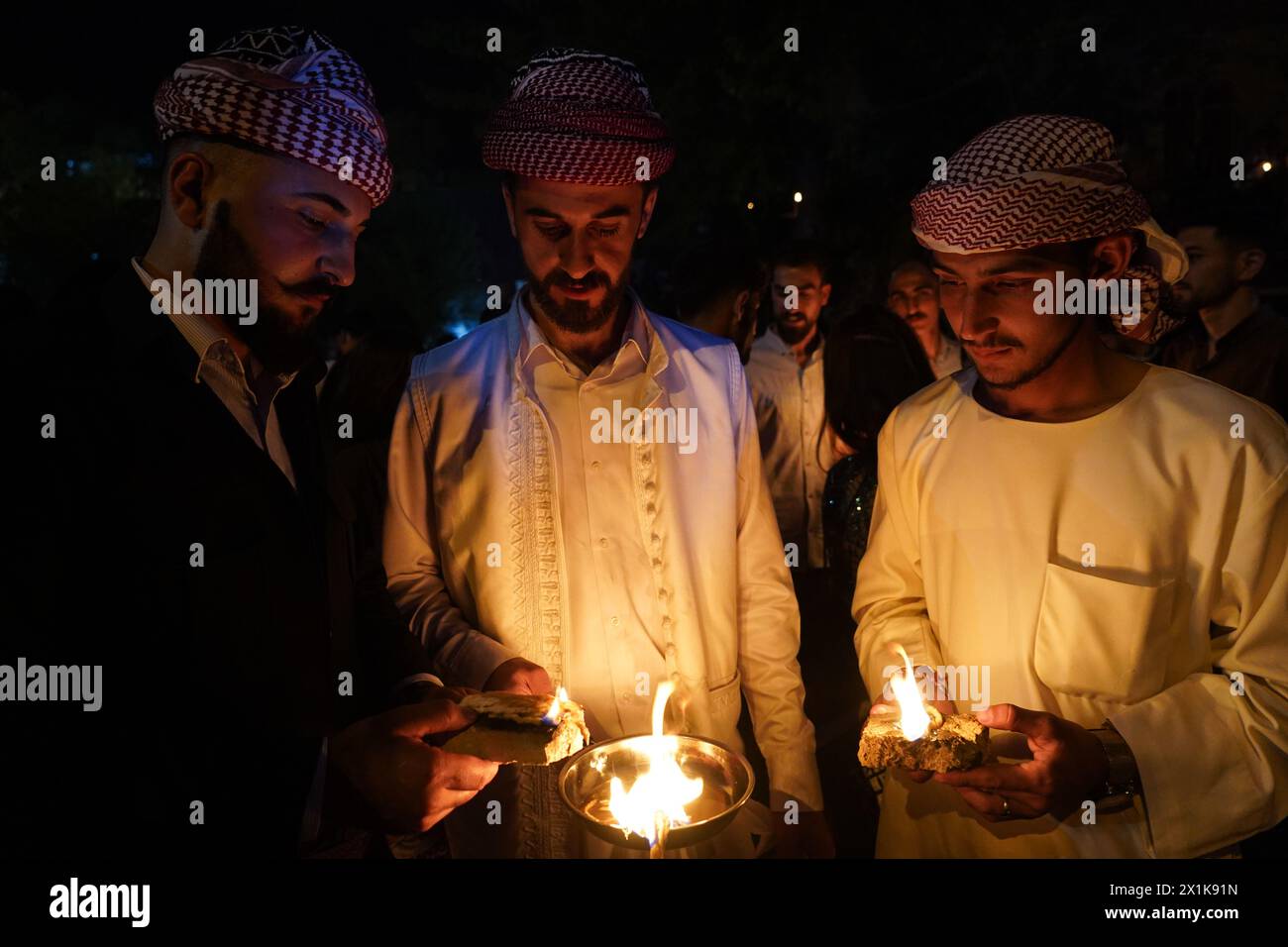 Iraqi Yazidi men light candles at Lalish mountain valley and temple ...