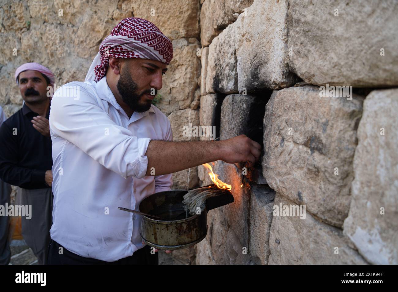 Lalish, Iraq. 16th Apr, 2024. Iraqi Yazidi man light candles at Lalish ...