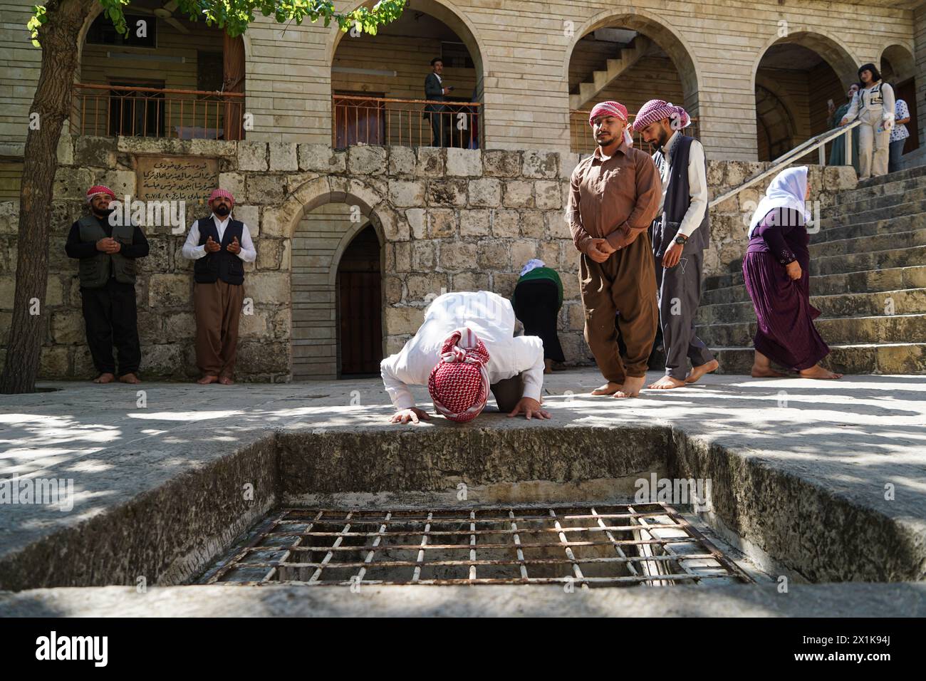 Lalish, Iraq. 16th Apr, 2024. Iraqi Yazidi man kisses ground at Lalish ...