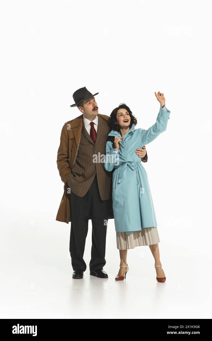 Beautiful couple wearing retro-styled clothes walking together, going ...