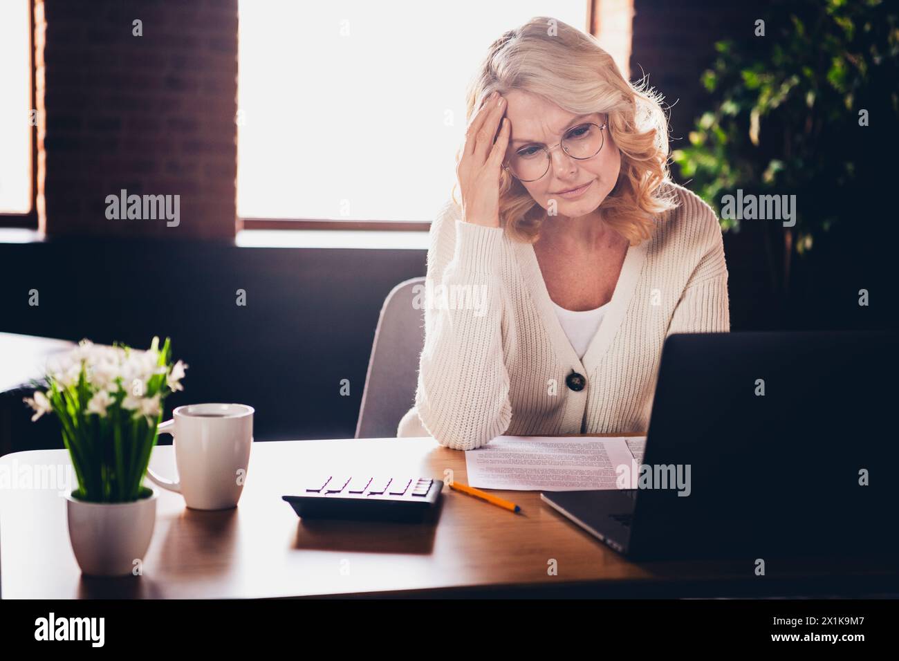 Portrait of aged lady focused attentive look laptop webinar wear white ...