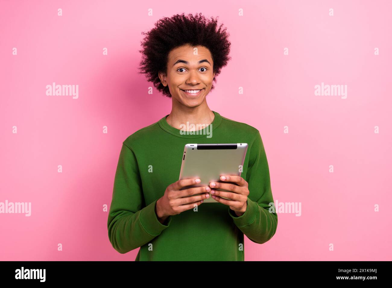 Photo of happy positive guy hold tablet using device isolated pastel ...