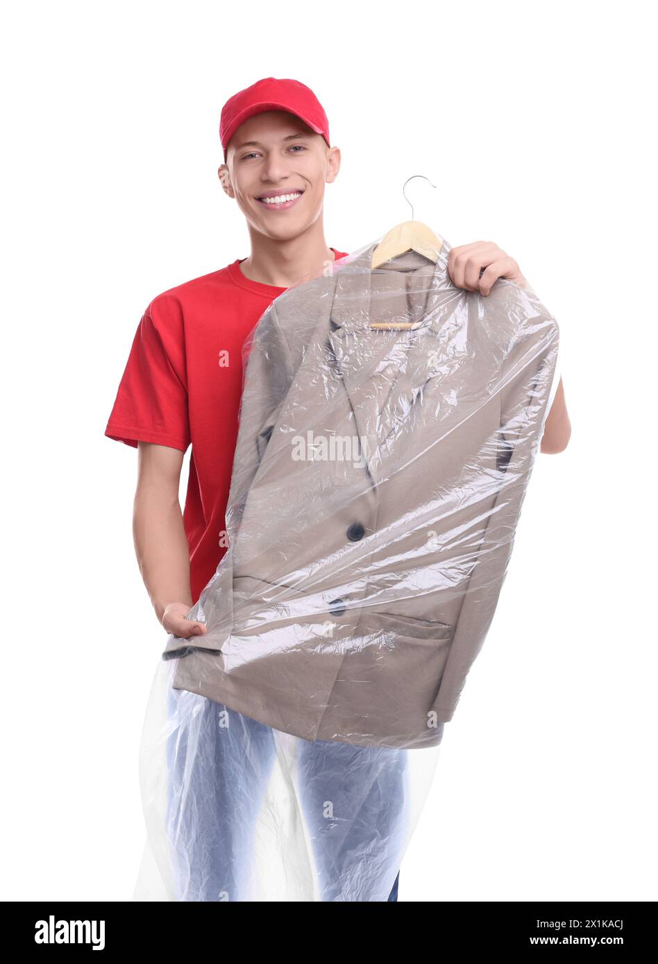Dry-cleaning delivery. Happy courier holding jacket in plastic bag on ...