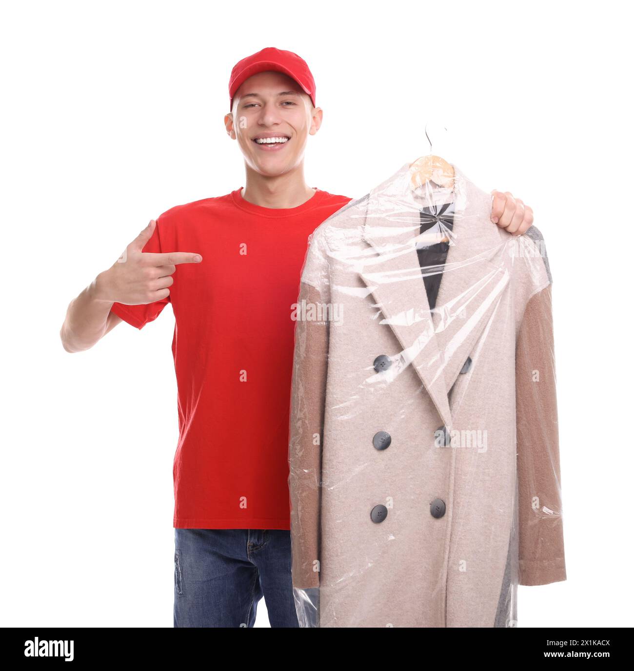 Dry-cleaning delivery. Happy courier holding coat in plastic bag on ...