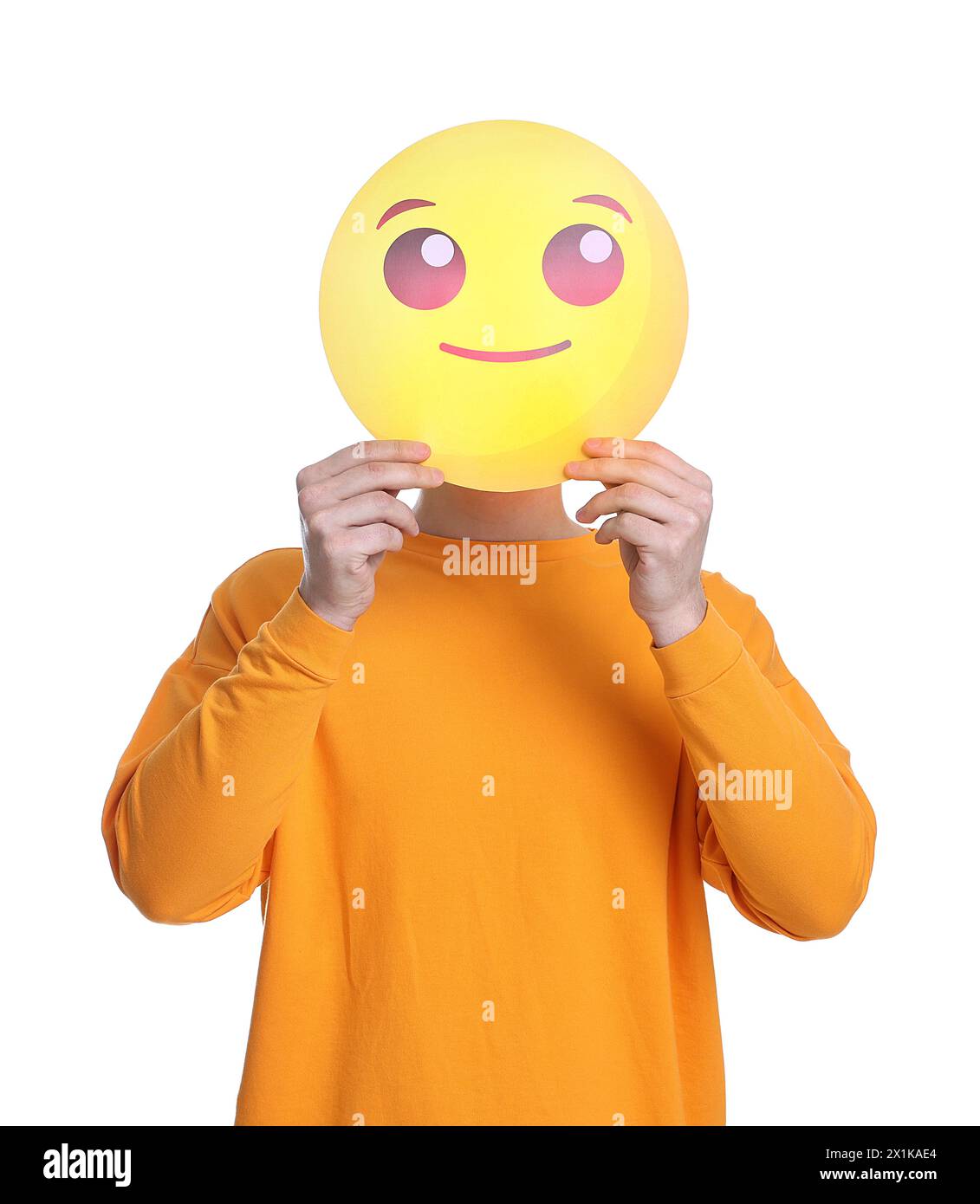 Man covering face with smiling emoticon on white background Stock Photo ...