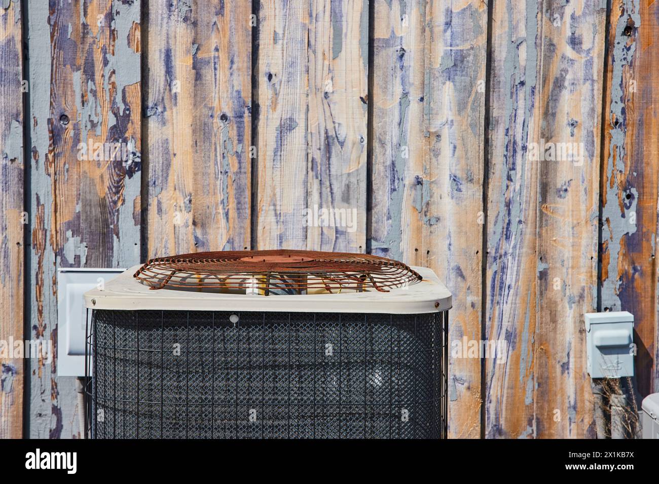 Aged HVAC Unit with Rusted Fan and Peeling Fence Background Stock Photo ...