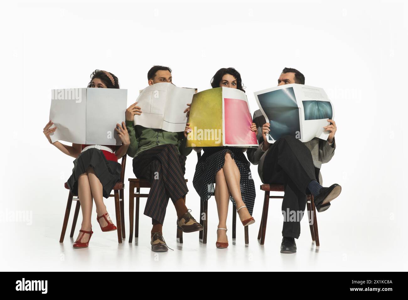 Group of four people, men and women in retro-style clothes sitting on ...