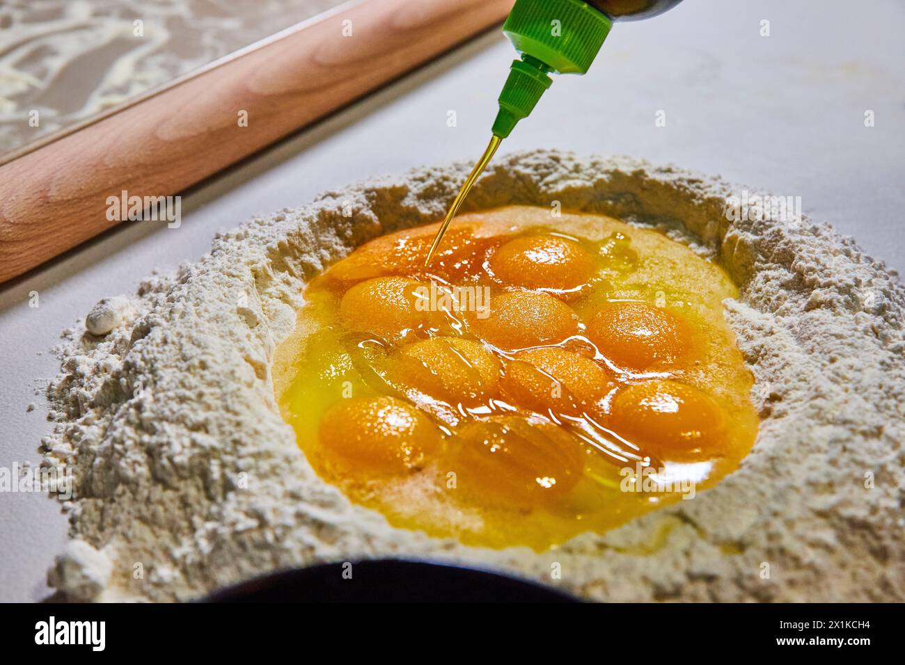 Egg Yolks in Flour Well with Olive Oil Pour - Close-Up Baking Prep ...