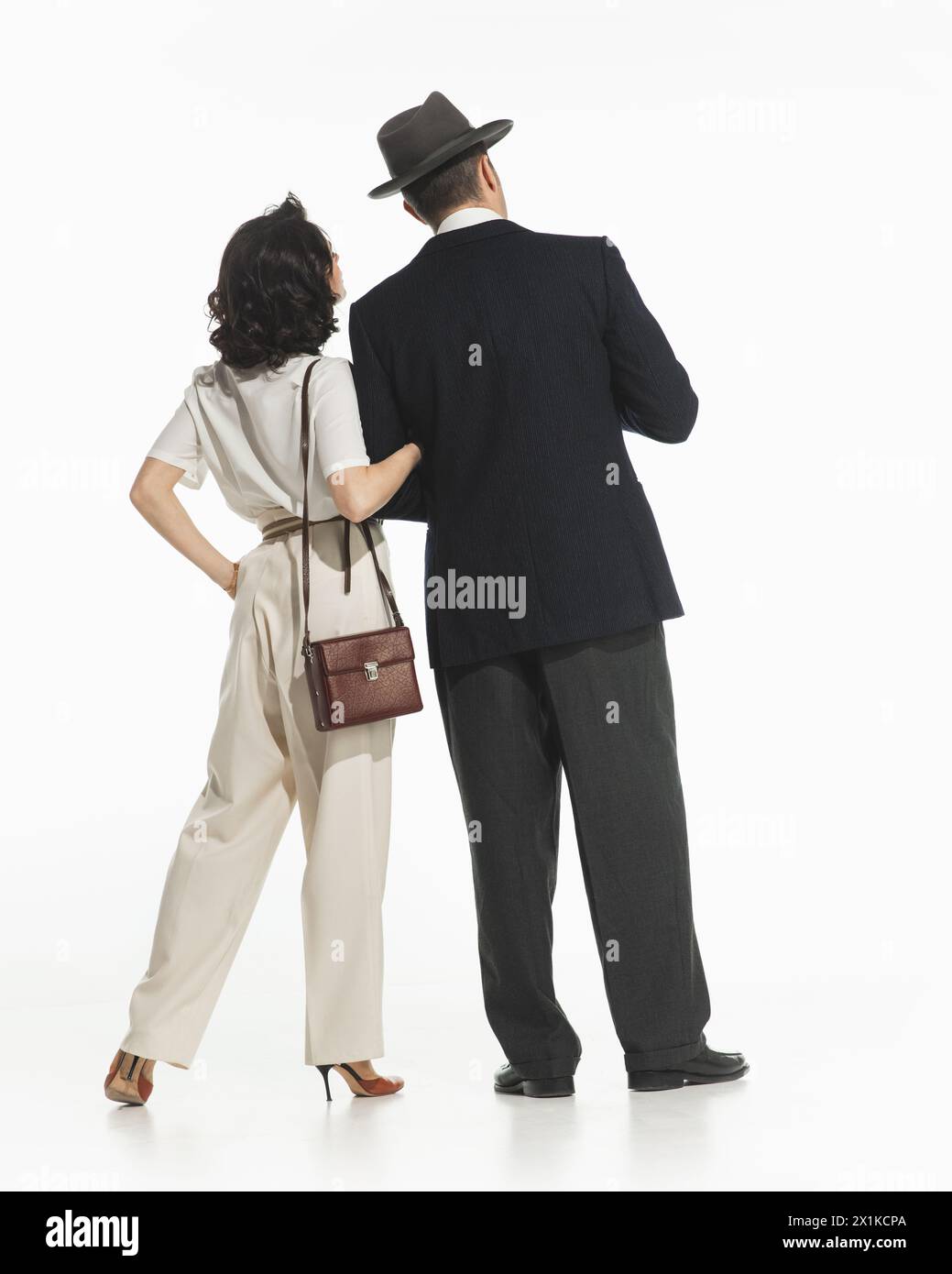 Man and woman in retro-style elegant costumes standing and looking ...
