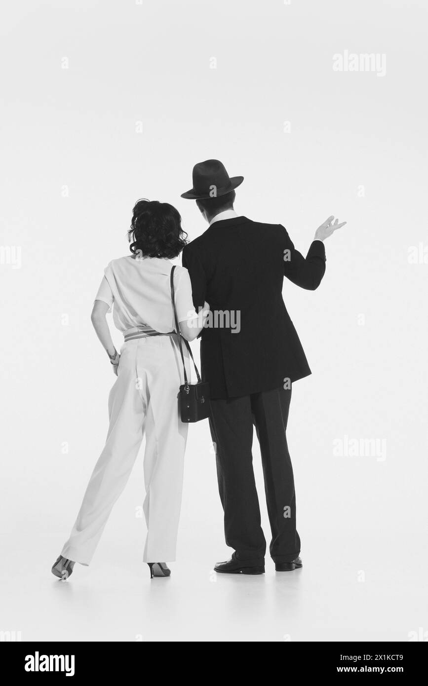 Man and woman in retro-style elegant costumes standing and looking ...