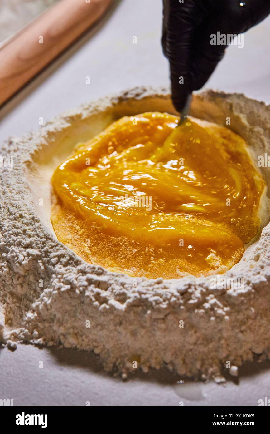Hand Mixing Yellow Dough on Kitchen Counter Stock Photo - Alamy