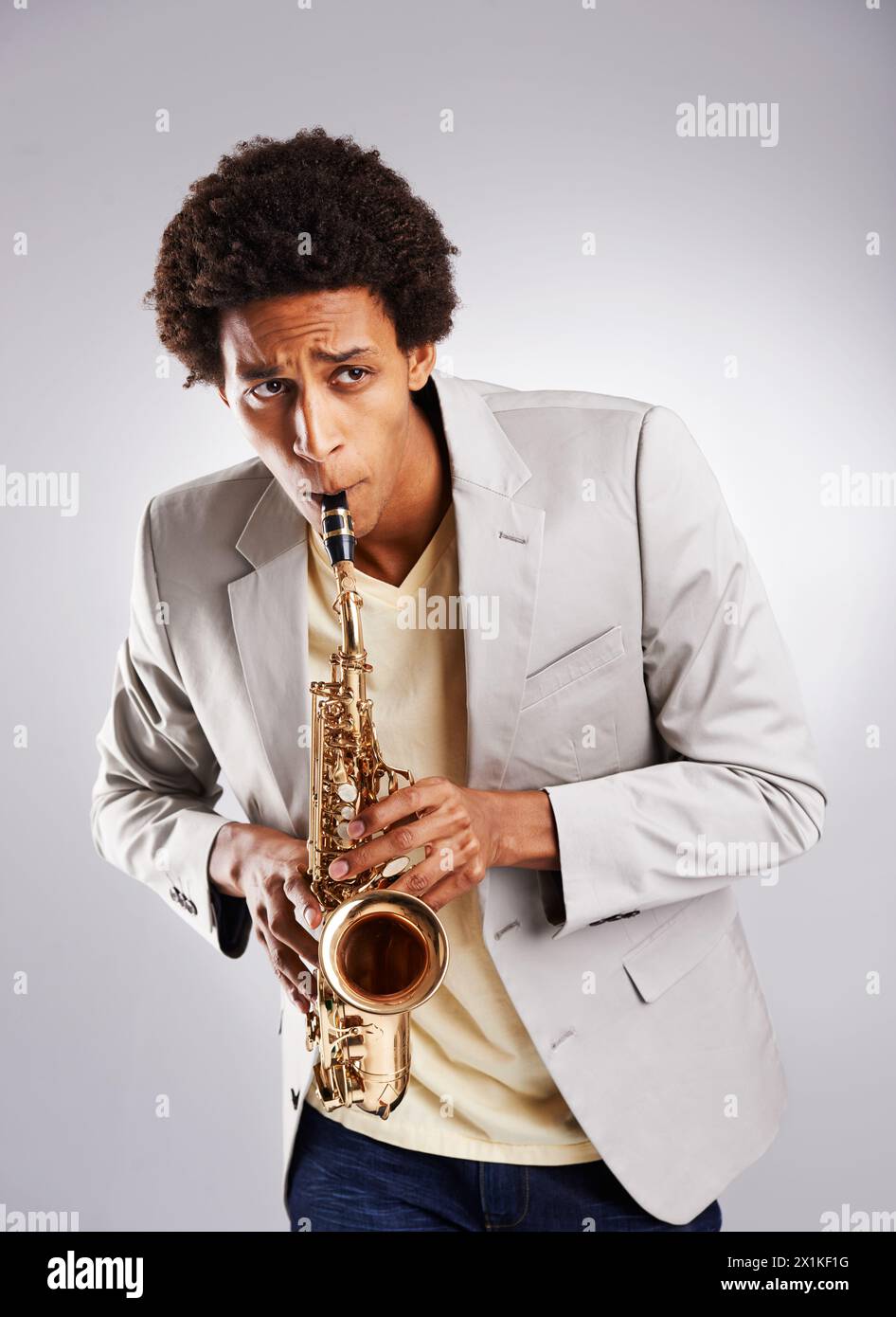Happy, african man and music, playing the saxophone with casual outfit ...