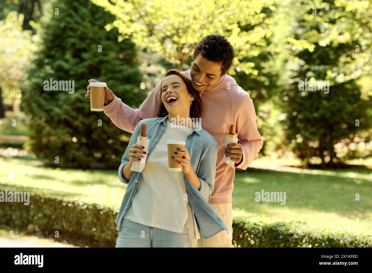 A stylish couple in vibrant attires enjoying coffee together in a park ...