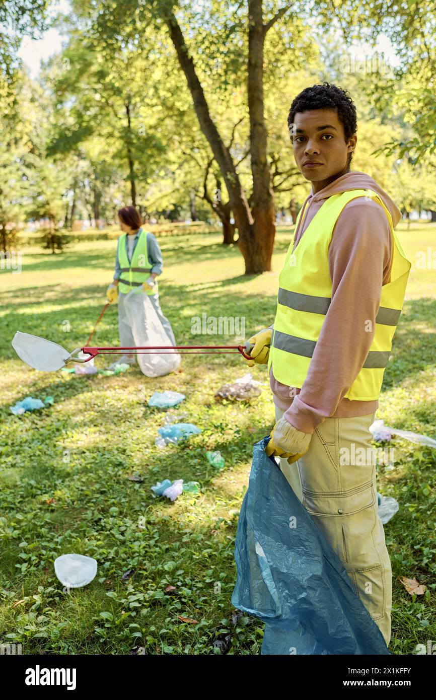 Socially active diverse couple cleaning a park together Stock Photo - Alamy