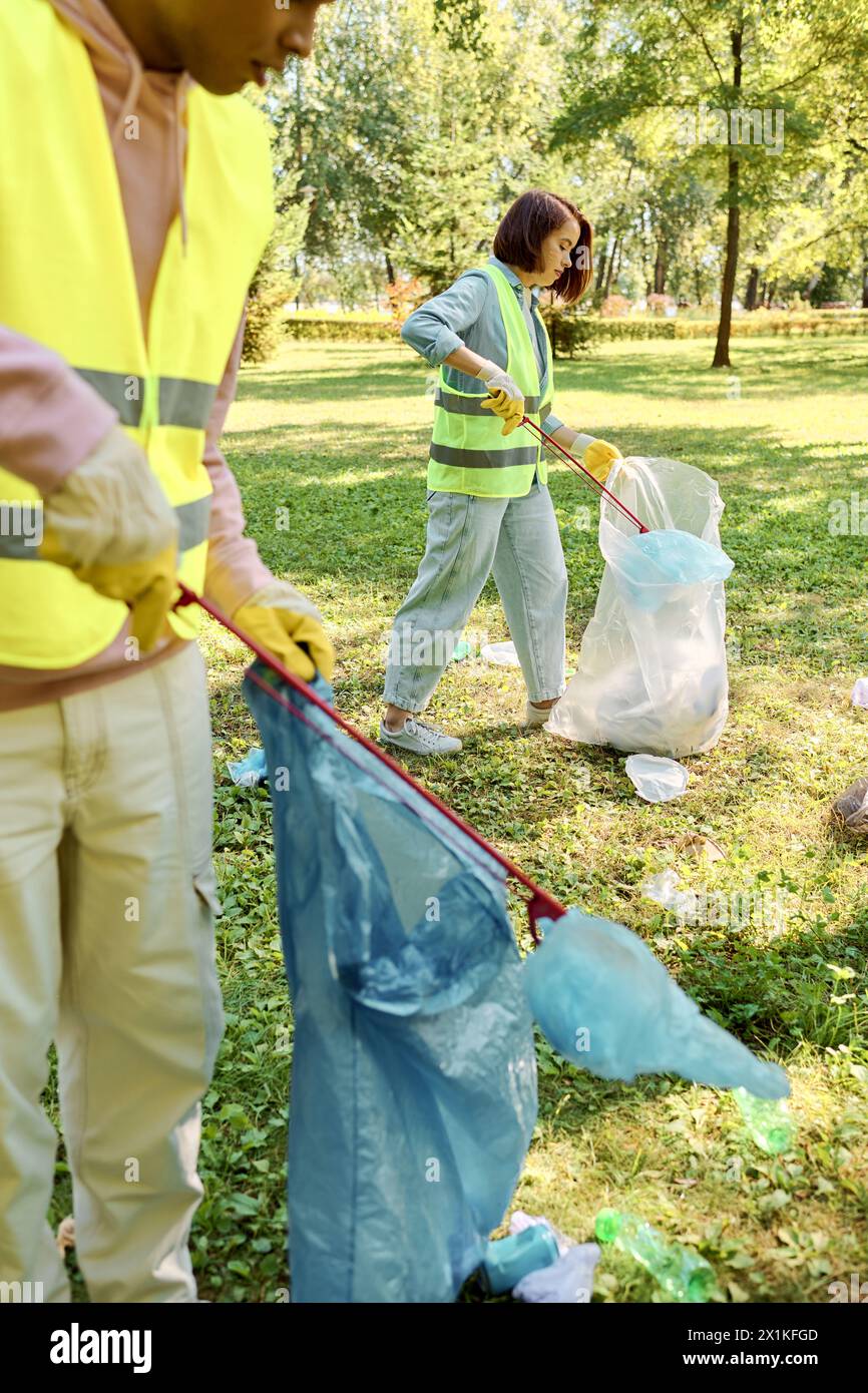 Socially active couple in safety vests and gloves working together to ...