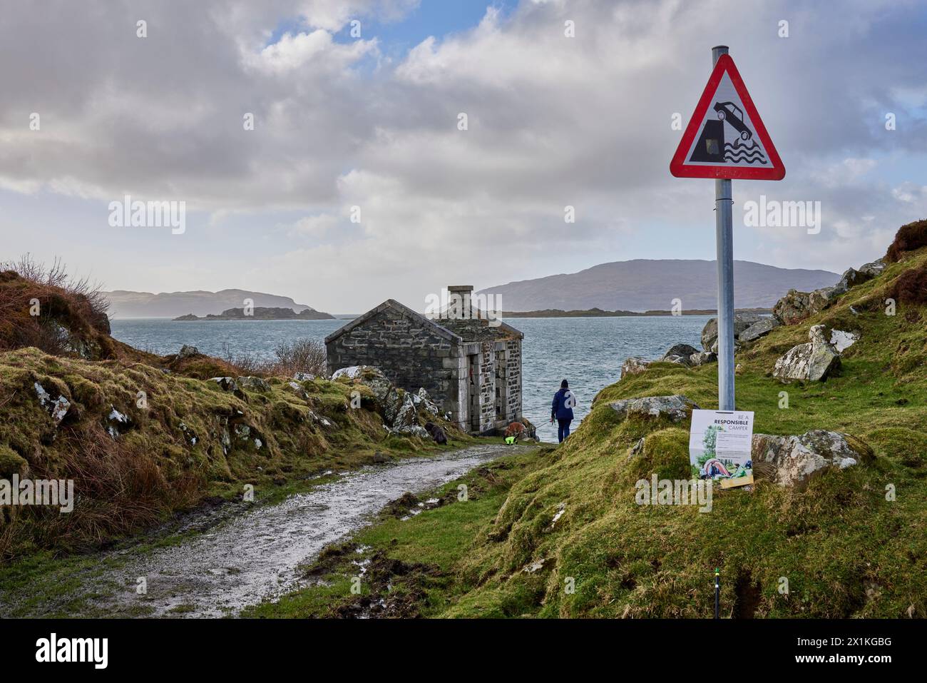An adult female exercises dogs at Craignish Point by Ardfern, Scotland ...
