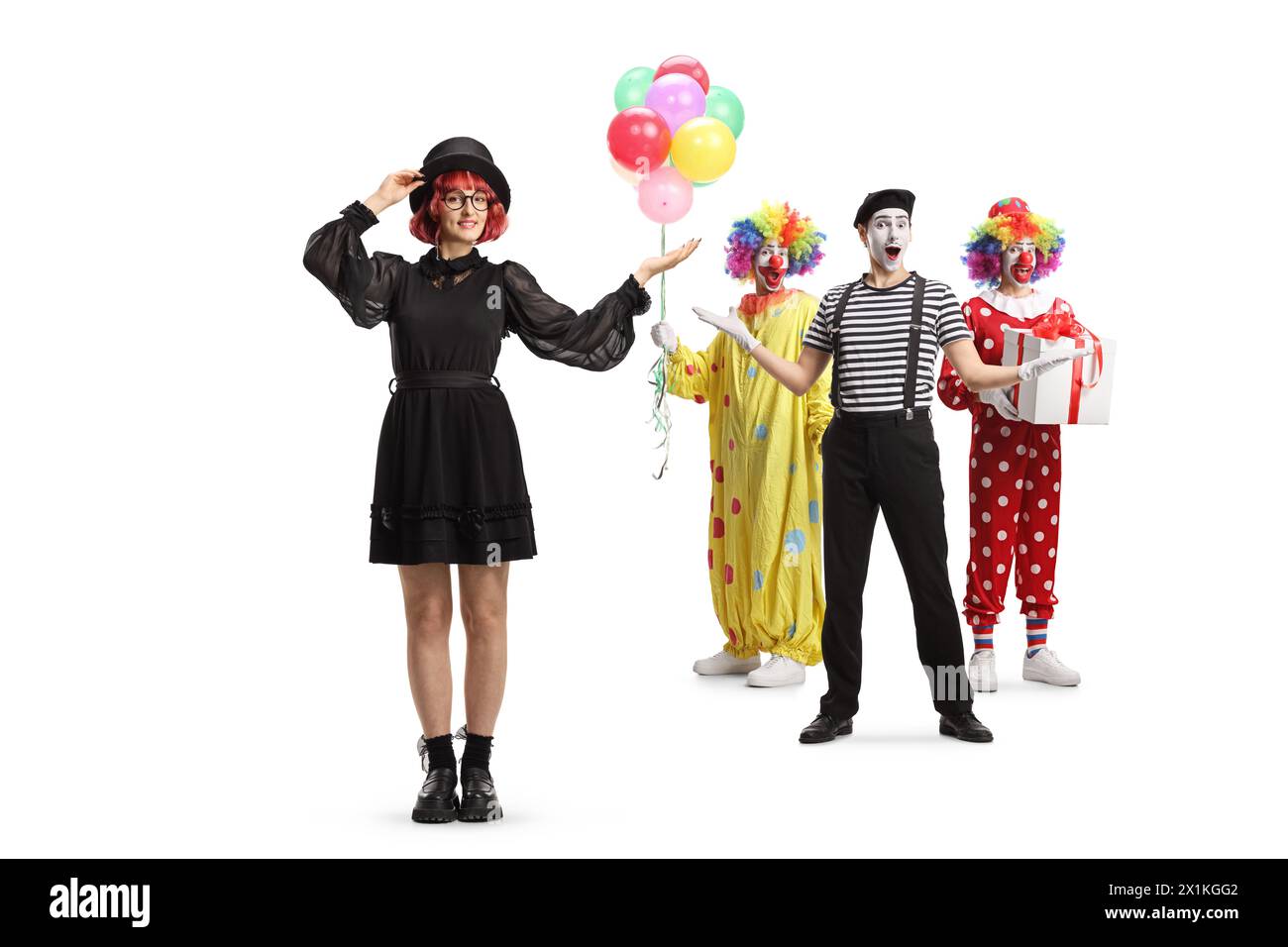 Female magician presenting clowns and a mime isolated on white ...