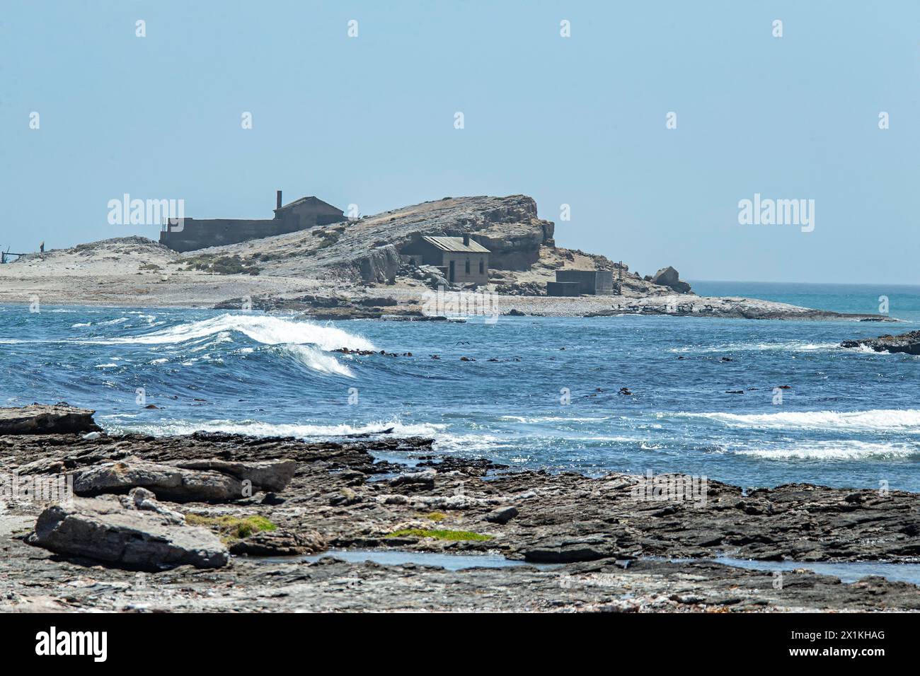 Deserted guano factory and cottages on the beach on Halifax Island over ...