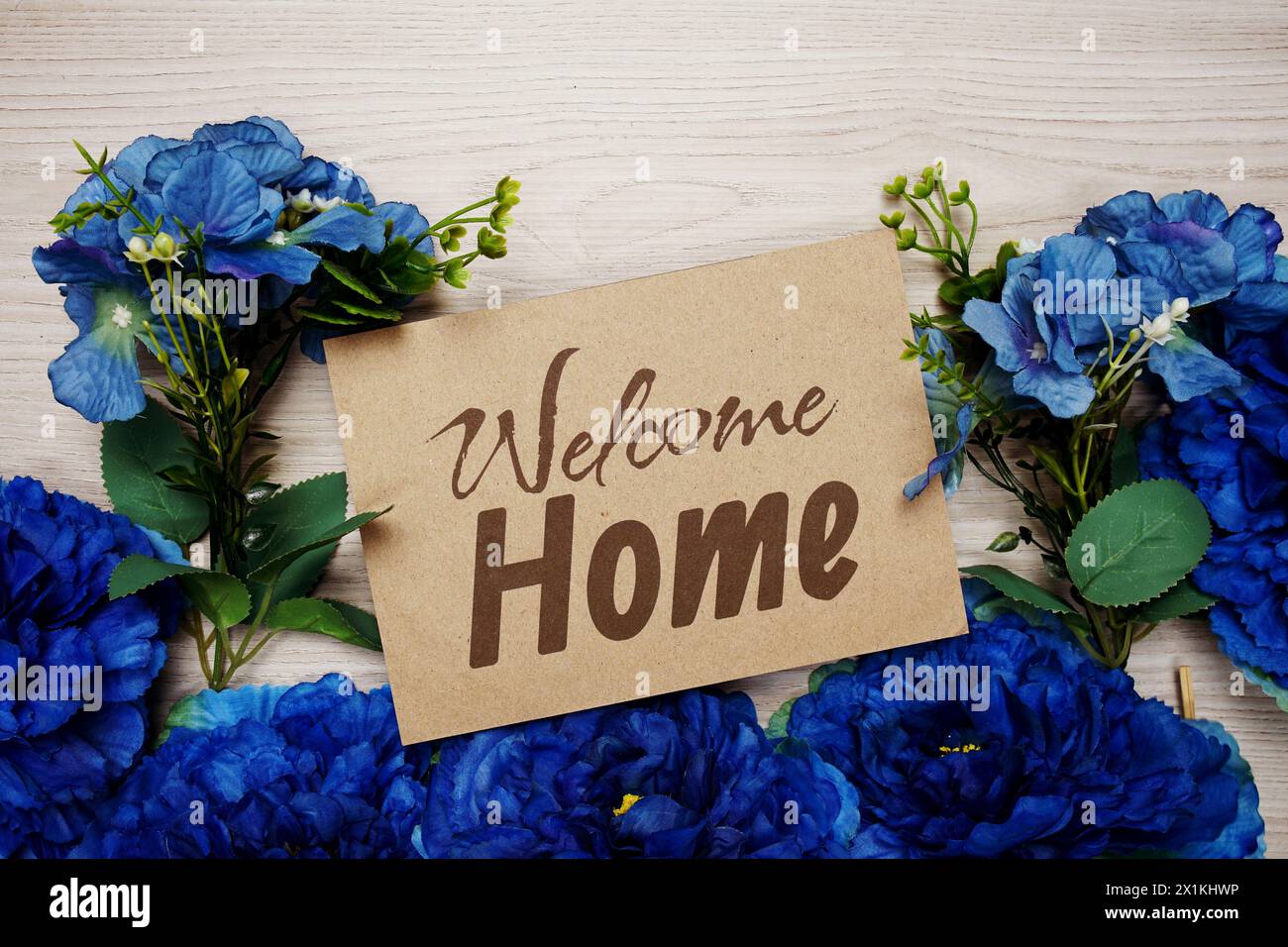 Welcome Home text message on paper card with flowers border frame on ...