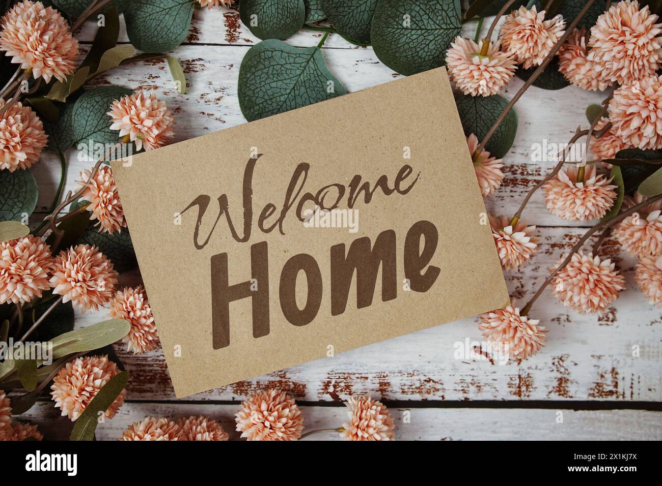 Welcome Home text message on paper card with flowers border frame on ...