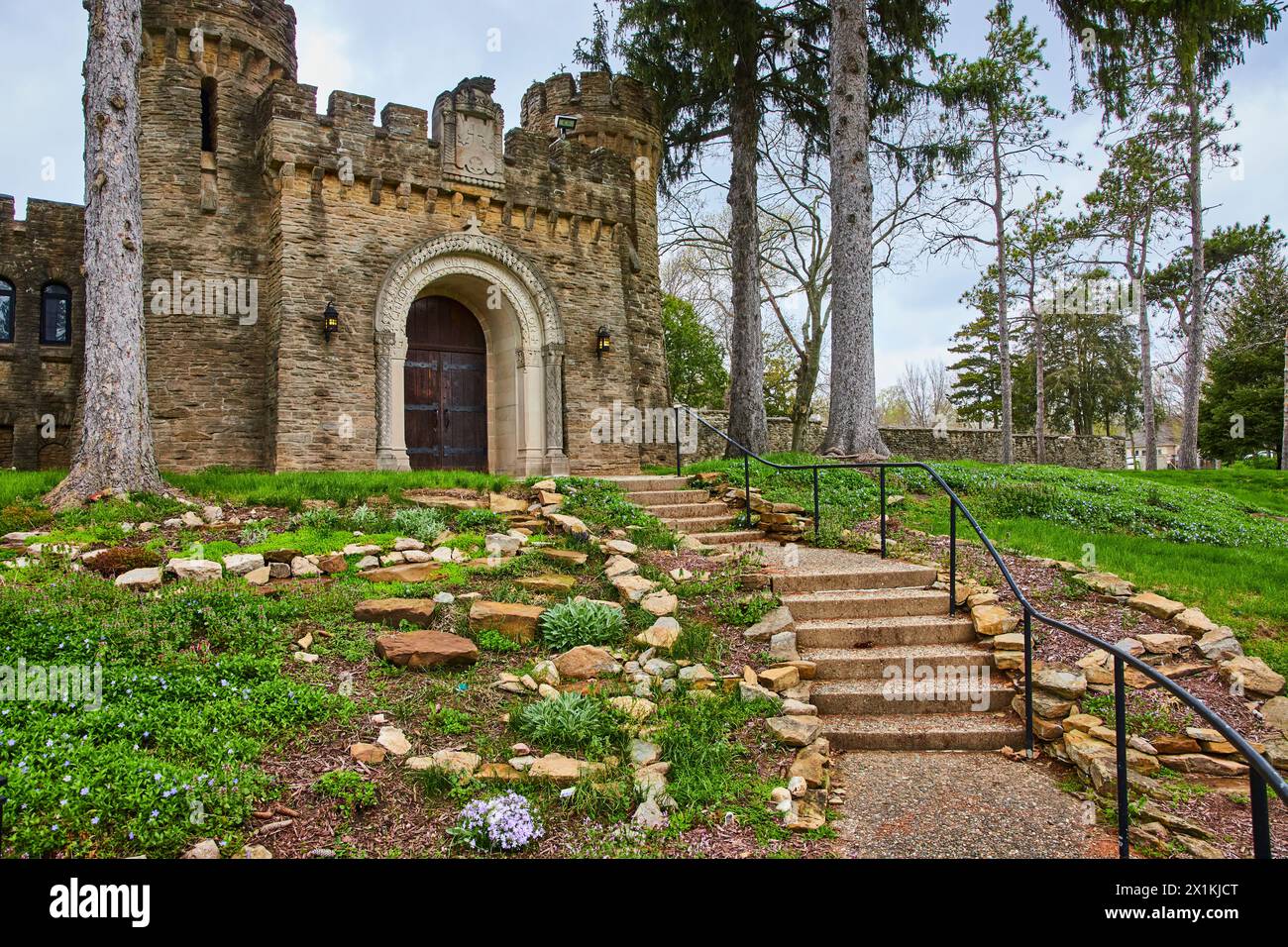 Majestic Castle Entrance with Blooming Garden Pathway Stock Photo - Alamy