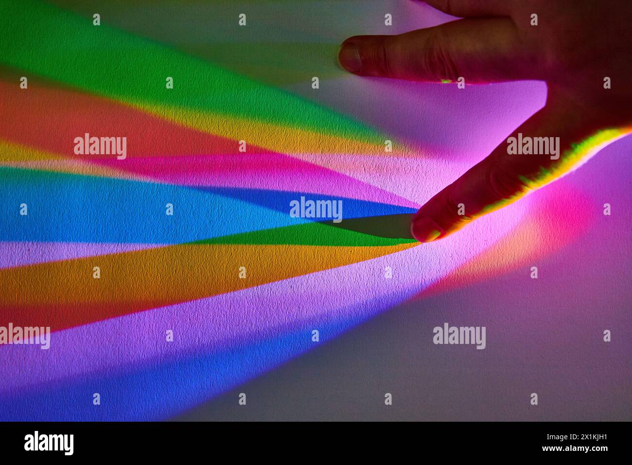 Hand Selecting Color from Rainbow Spectrum Display Stock Photo - Alamy