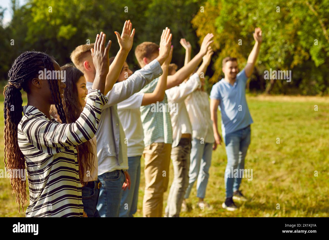 Young diverse audience raising hands to ask questions at youth forum in ...