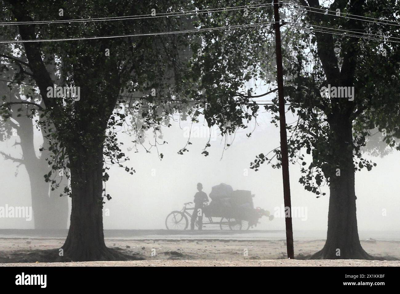 Prayagraj, India. 17 April 2024, A rickshaw puller take rest during ...
