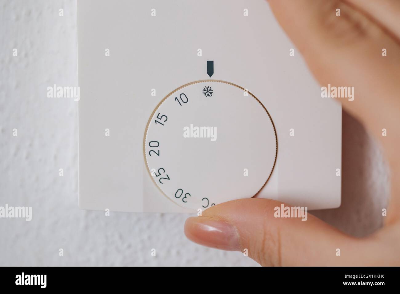Close-up of human hand turns off the heating at home. Central Heating ...