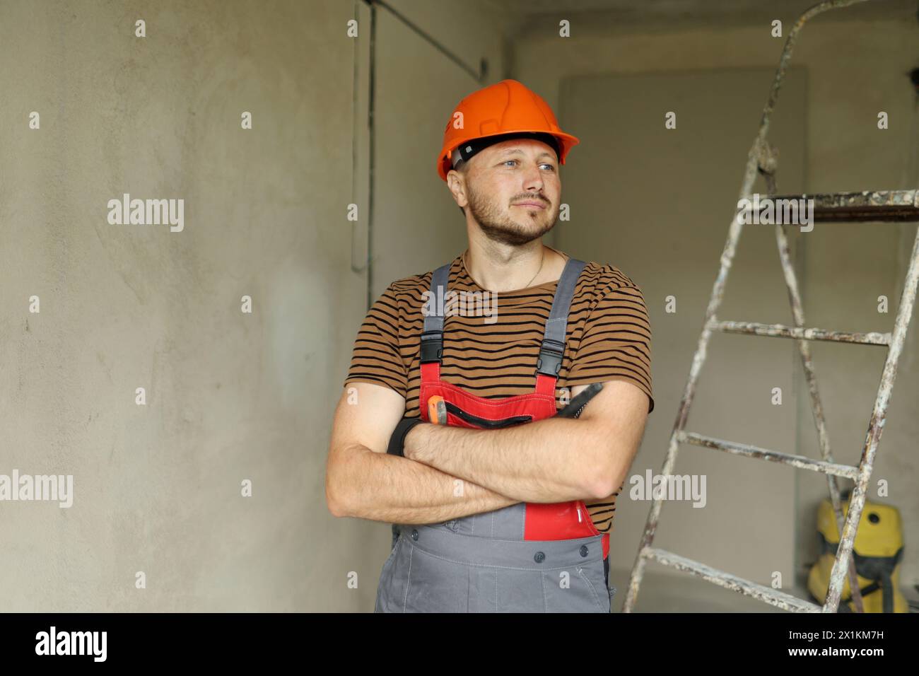 Renovation apartment. Portrait of young confident male foreman ...