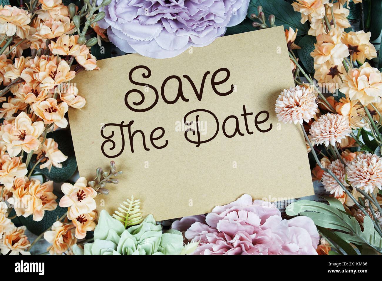Save the Date typography text with flower decorated on wooden ...