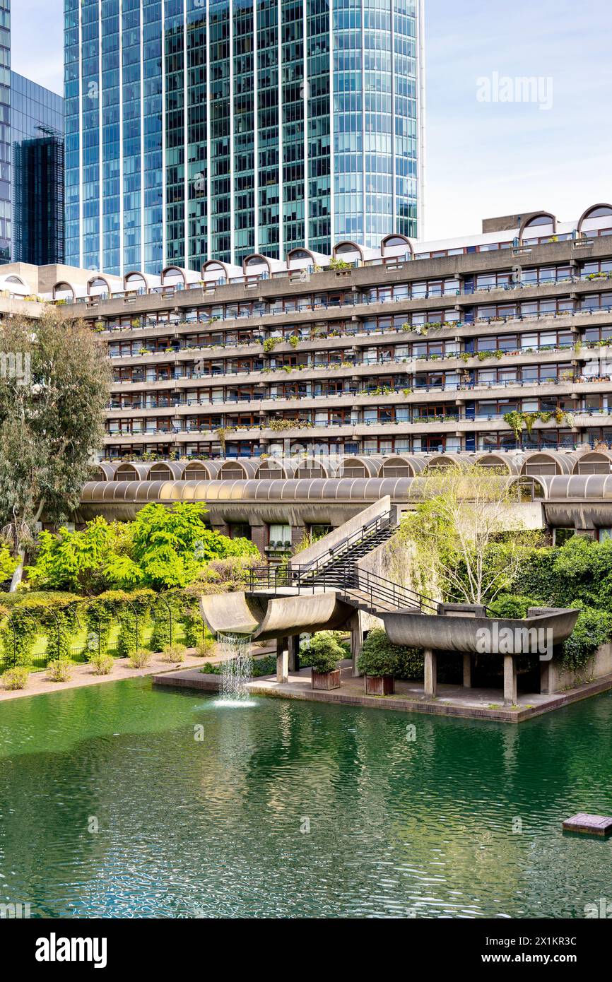A waterfall feature at the Barbican Estate pond with Willoughby House ...