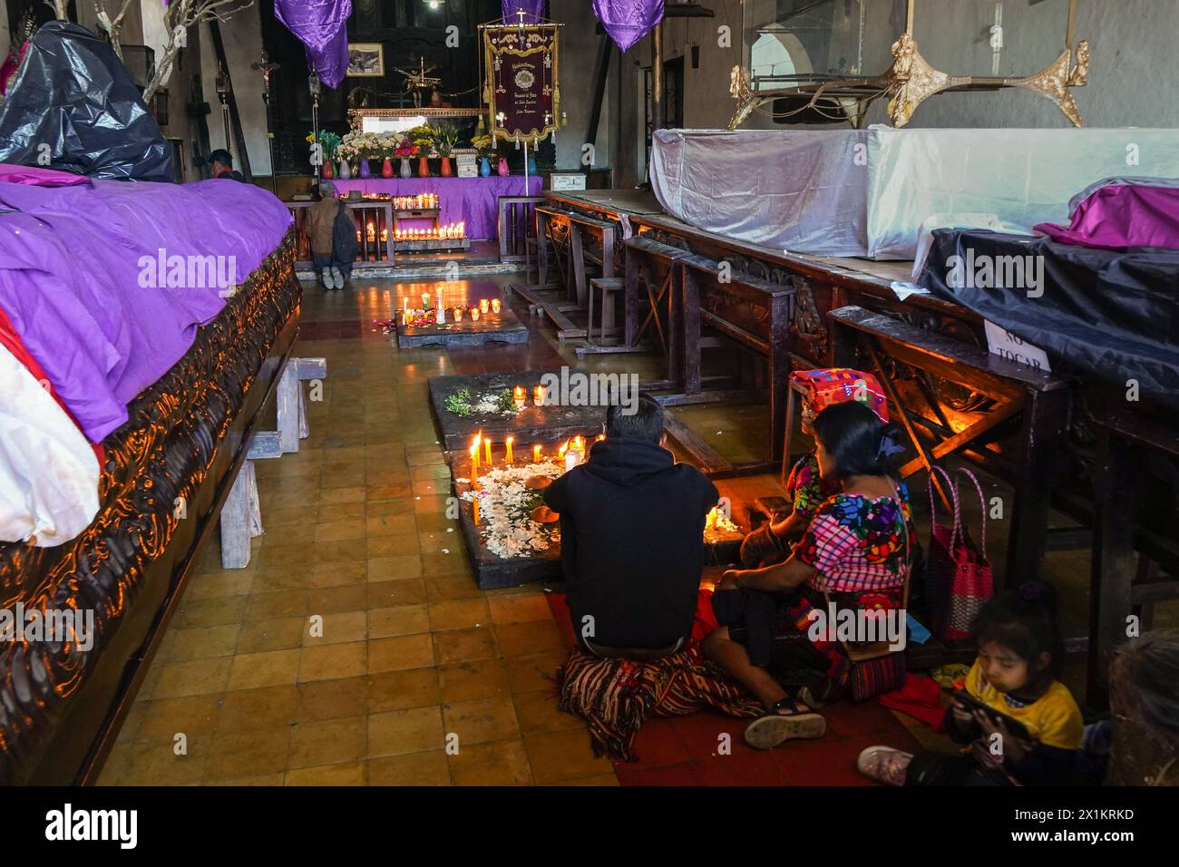 Mayan indigenous people pray and burn candles on altar platforms inside ...