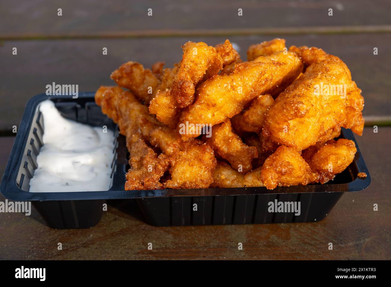 Seafood, outdoor eating of diep-fried cod fish pieces served with ...