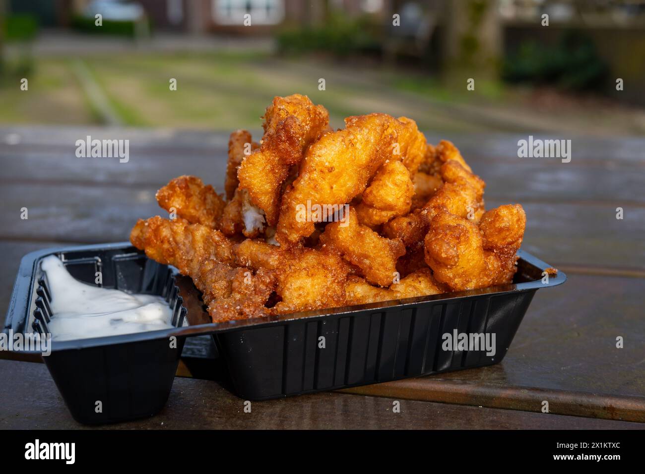 Seafood, outdoor eating of diep-fried cod fish pieces served with ...
