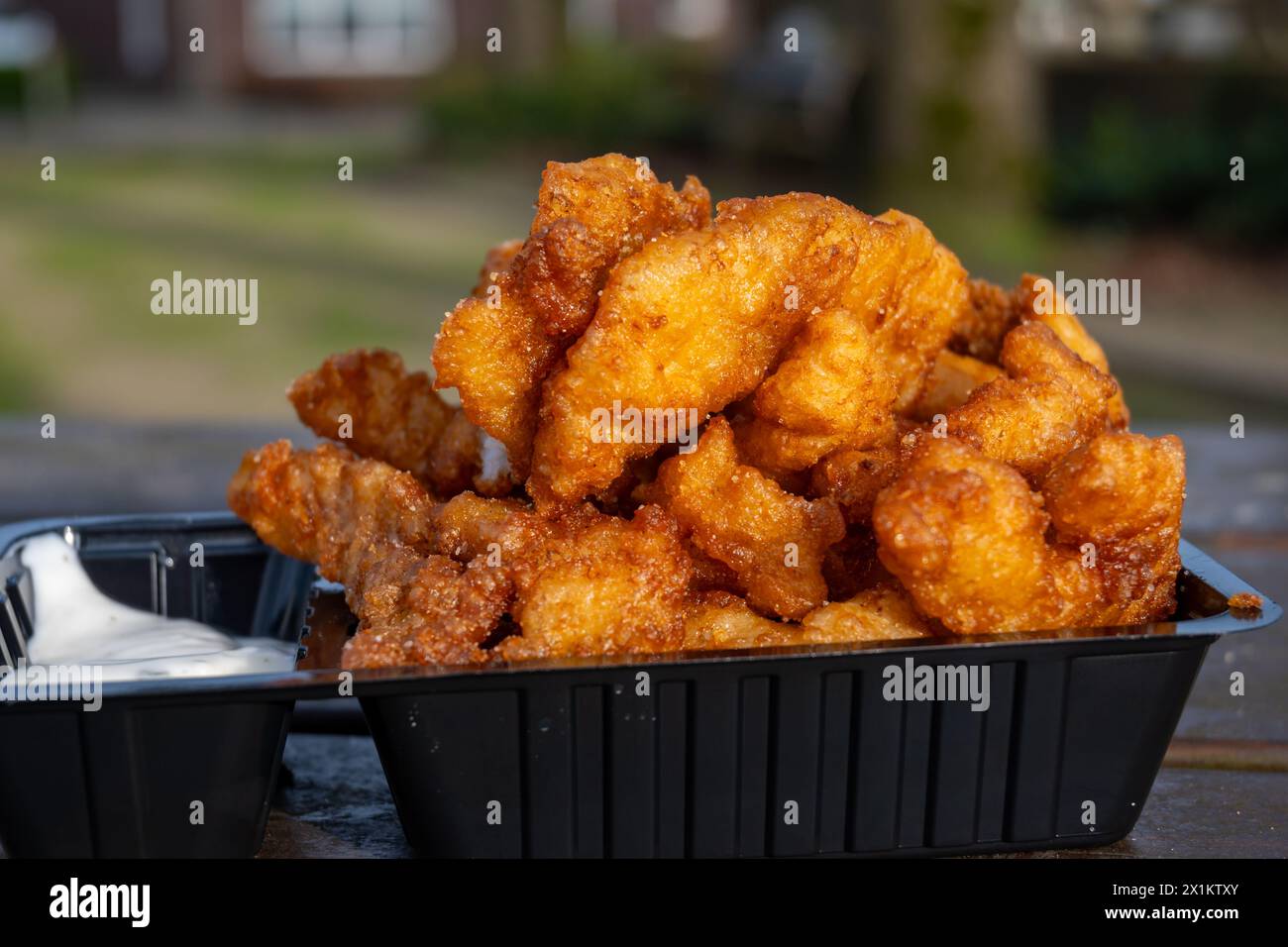Seafood, outdoor eating of diep-fried cod fish pieces served with ...