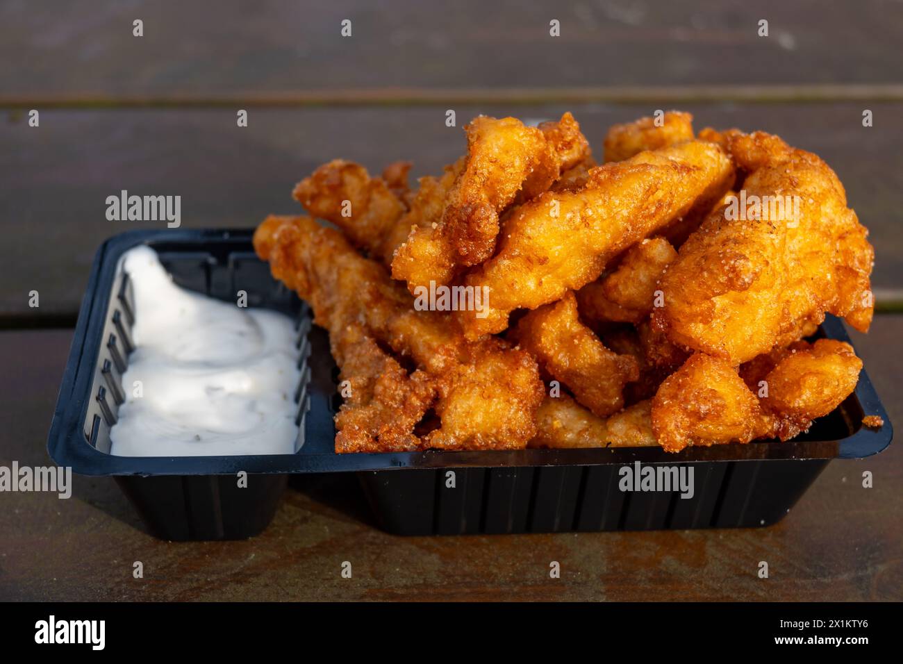 Seafood, outdoor eating of diep-fried cod fish pieces served with ...