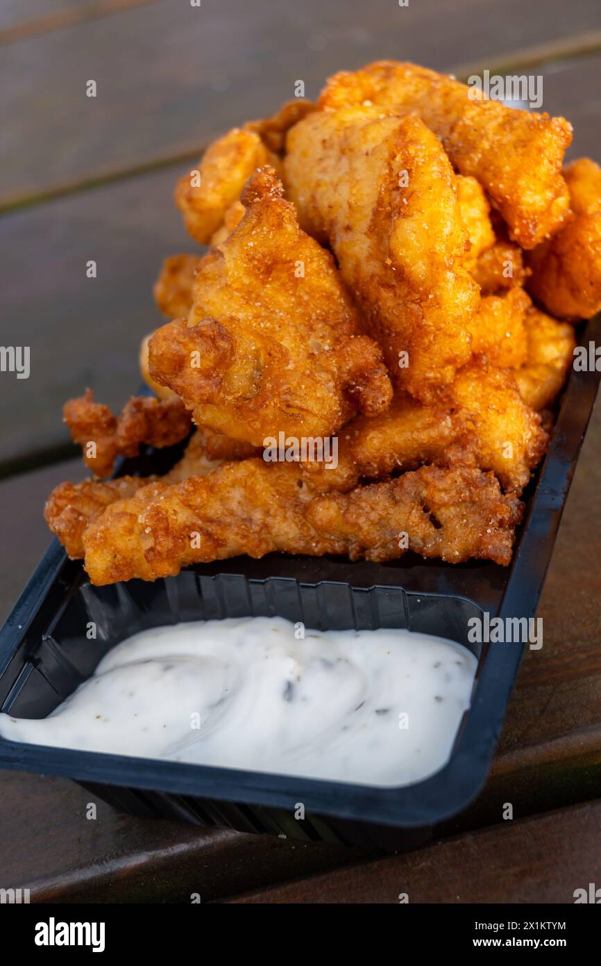 Seafood, outdoor eating of diep-fried cod fish pieces served with ...